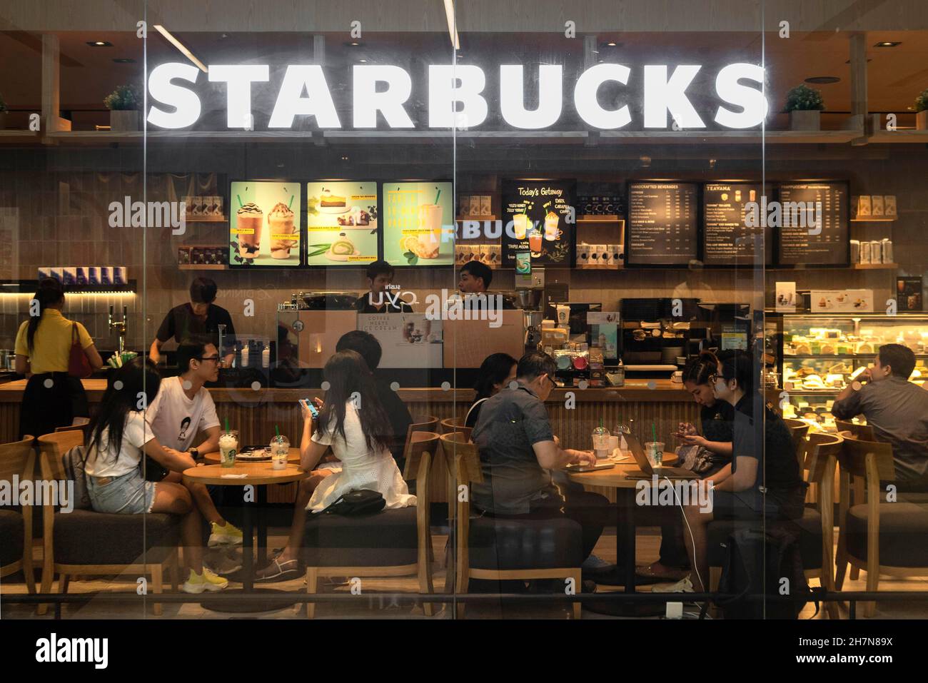 Starbucks shop window illuminated, Bangkok, Thailand Stock Photo - Alamy