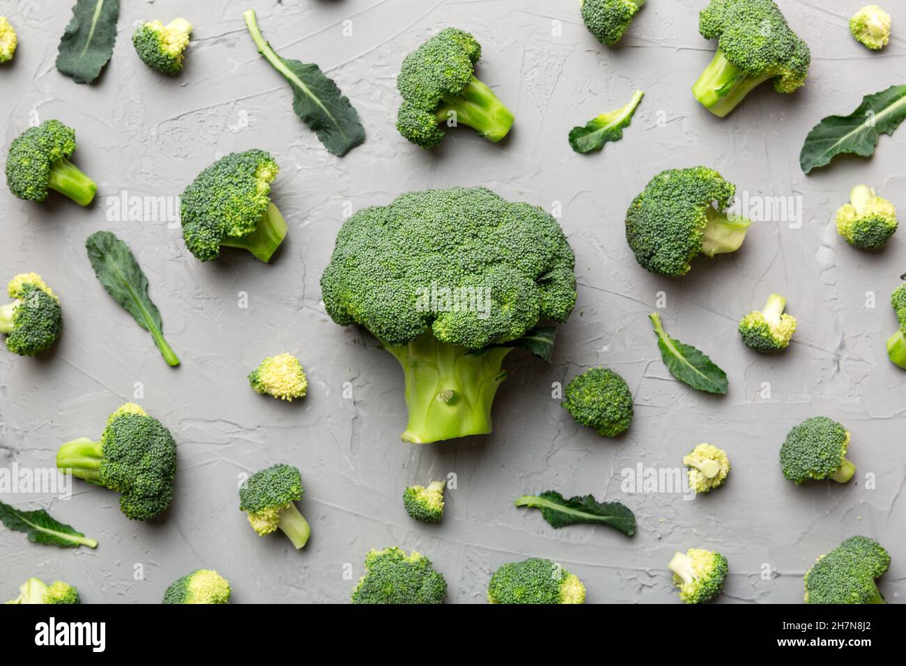 green fresh broccoli background close up on colored table. Vegetables ...