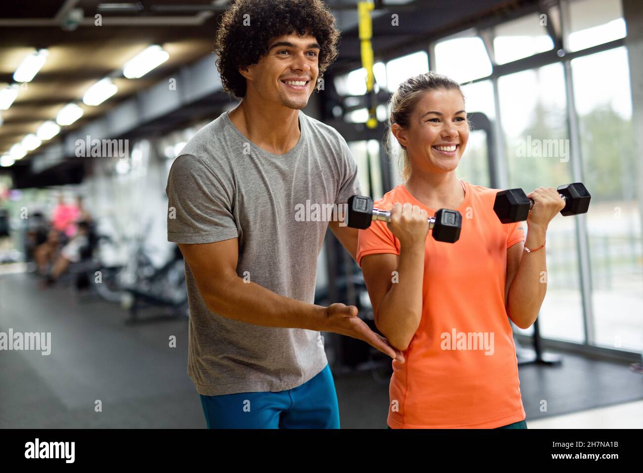 Portrait of happy fit people, friends exercising in gym together. Sport ...