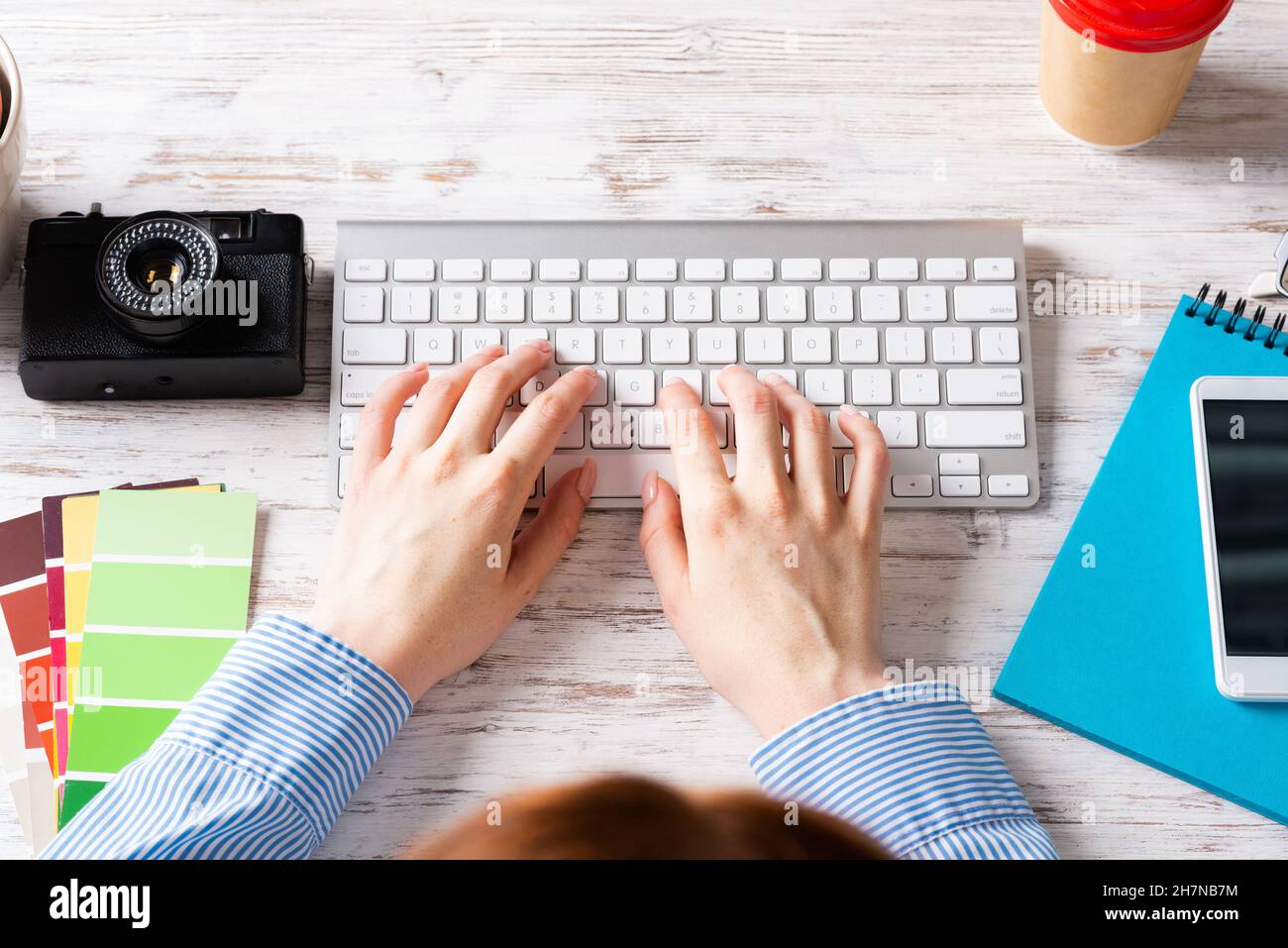 Freelancer sitting at desk and typing on keyboard Stock Photo - Alamy
