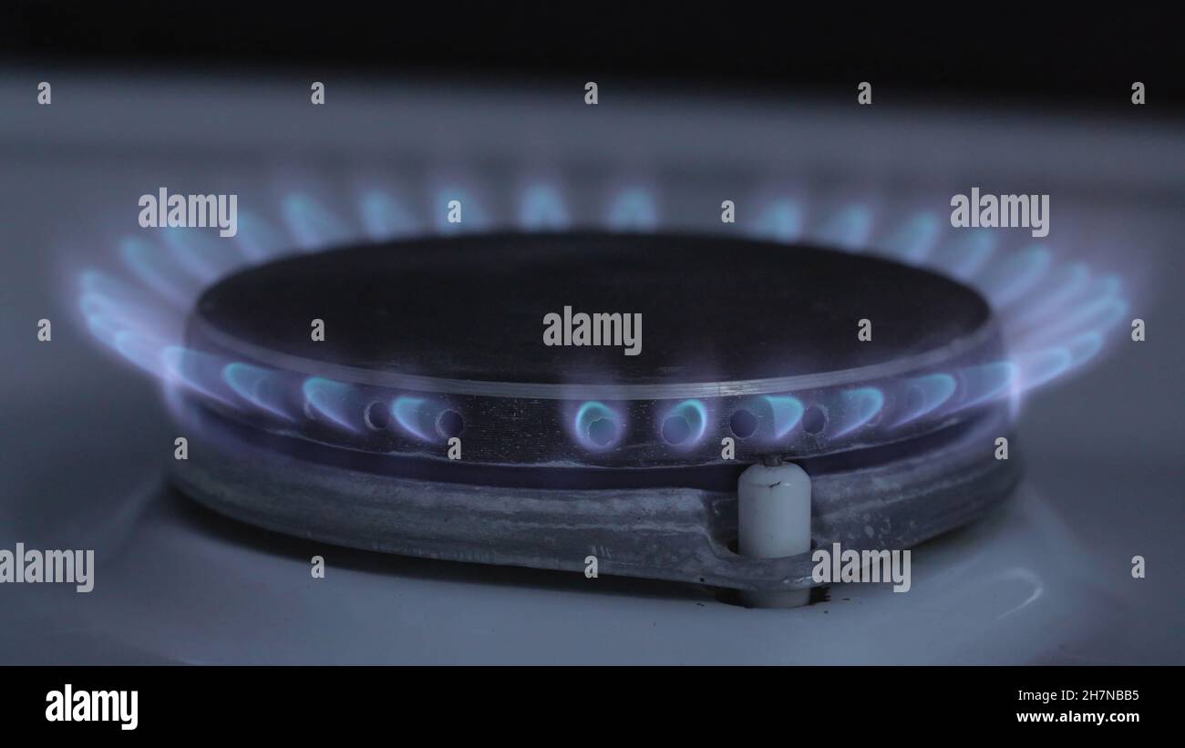 Photo of glowing gas stove with blue light Stock Photo - Alamy