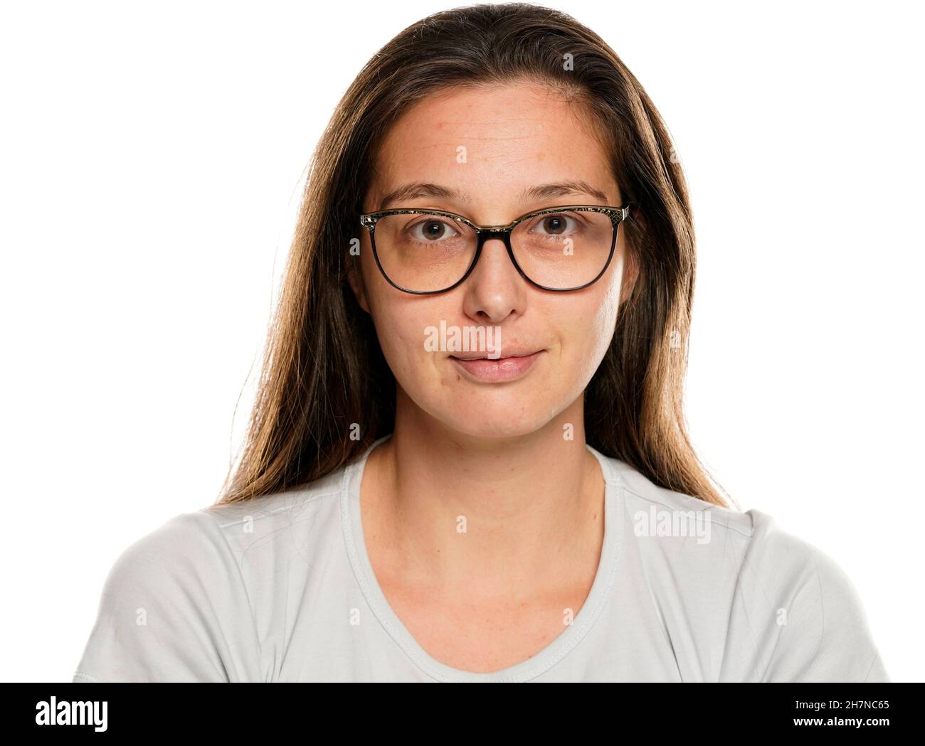 Portrait of young smiling woman with glasses and without makeup on ...