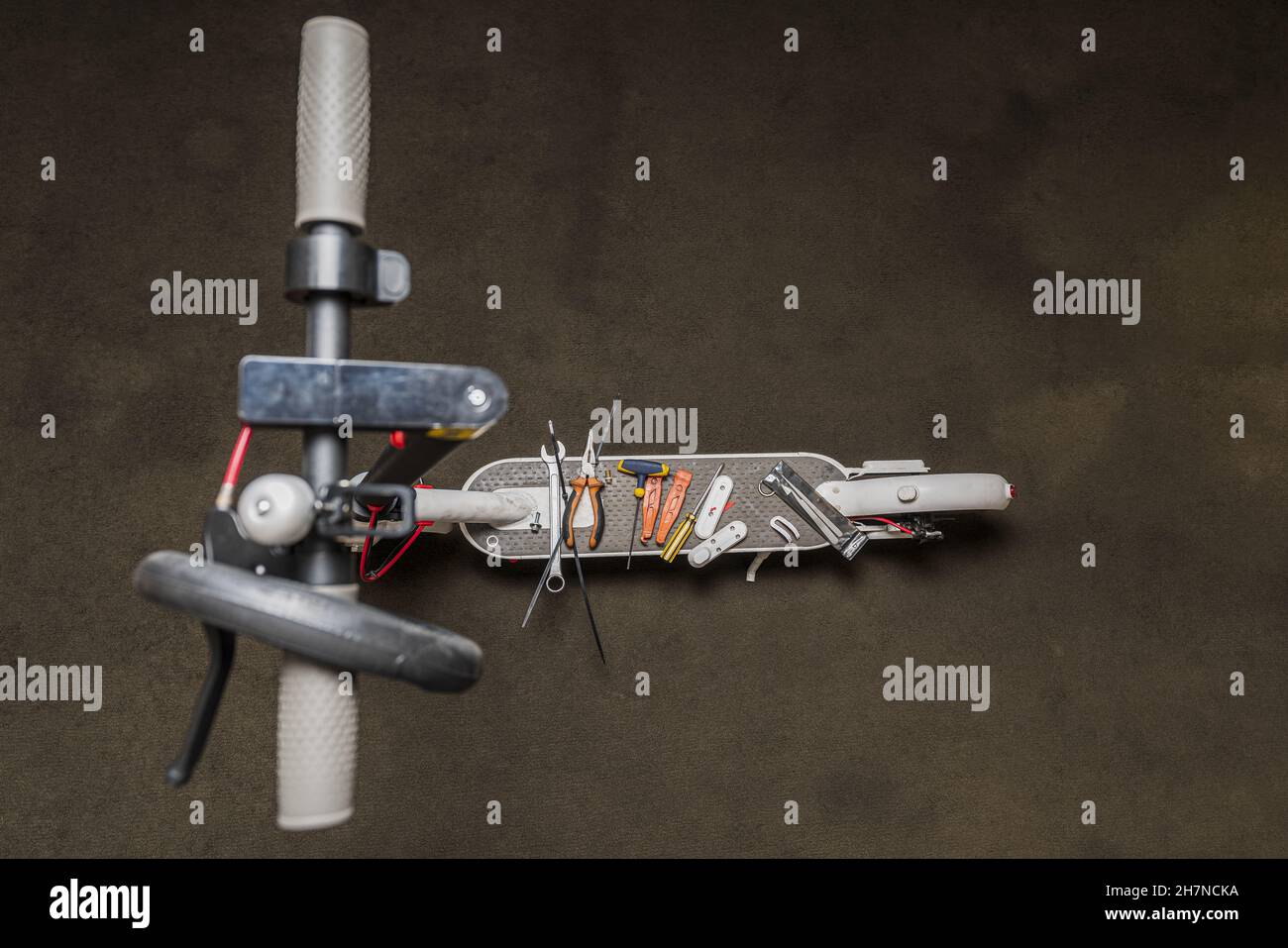 Top view of an electric scooter in a mechanic's workshop for repair ...