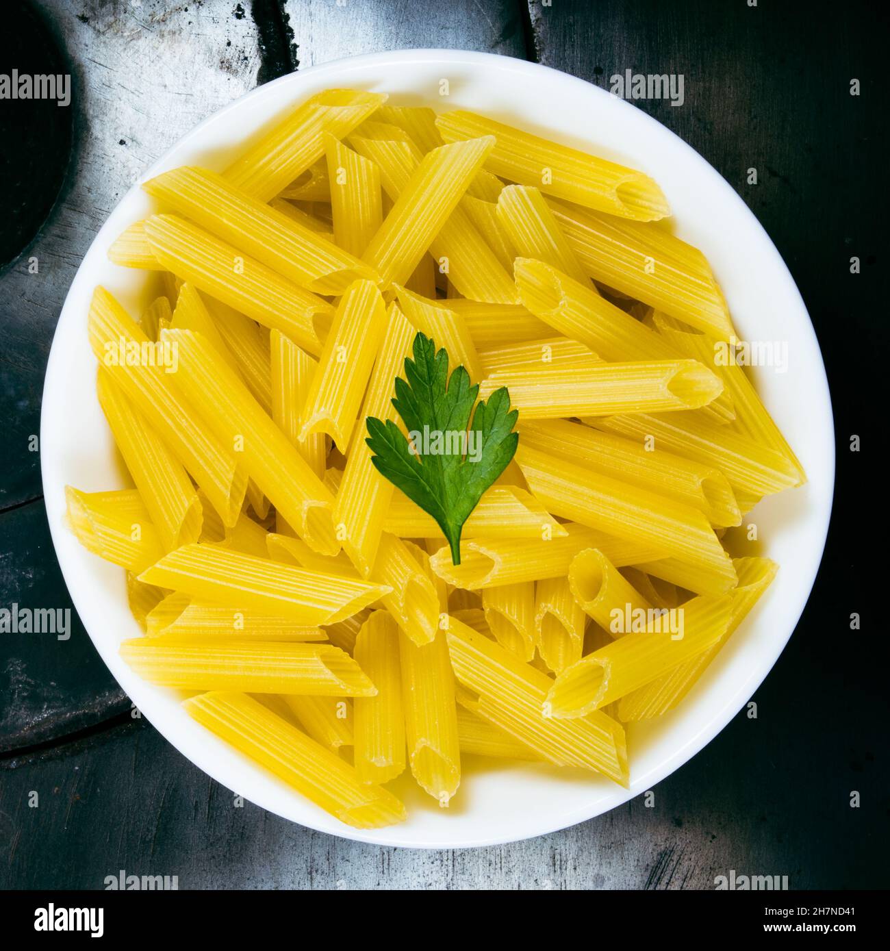 Top view of raw penne pasta in a bowl Stock Photo - Alamy