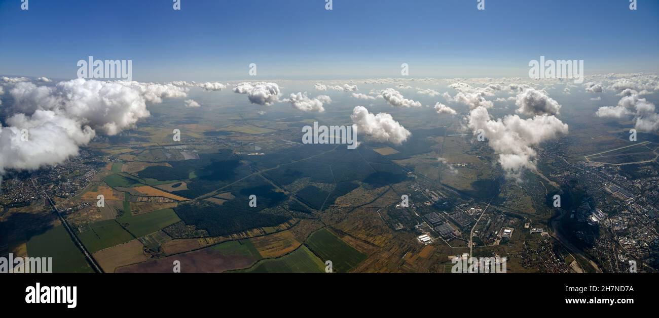 Aerial view from airplane window at high altitude of distant city ...