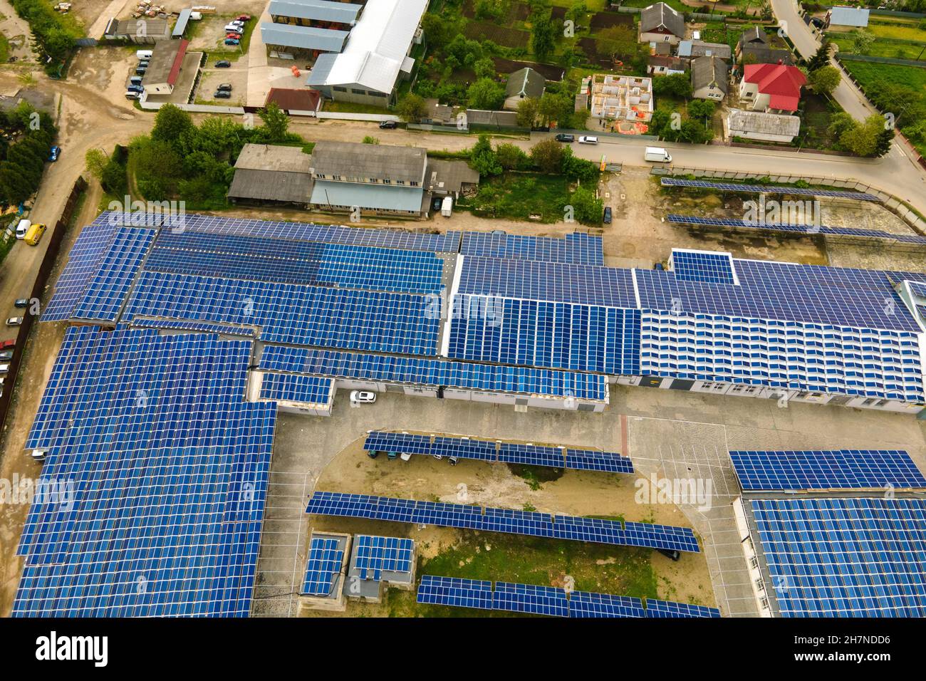 Aerial view of blue photovoltaic solar panels mounted on industrial ...