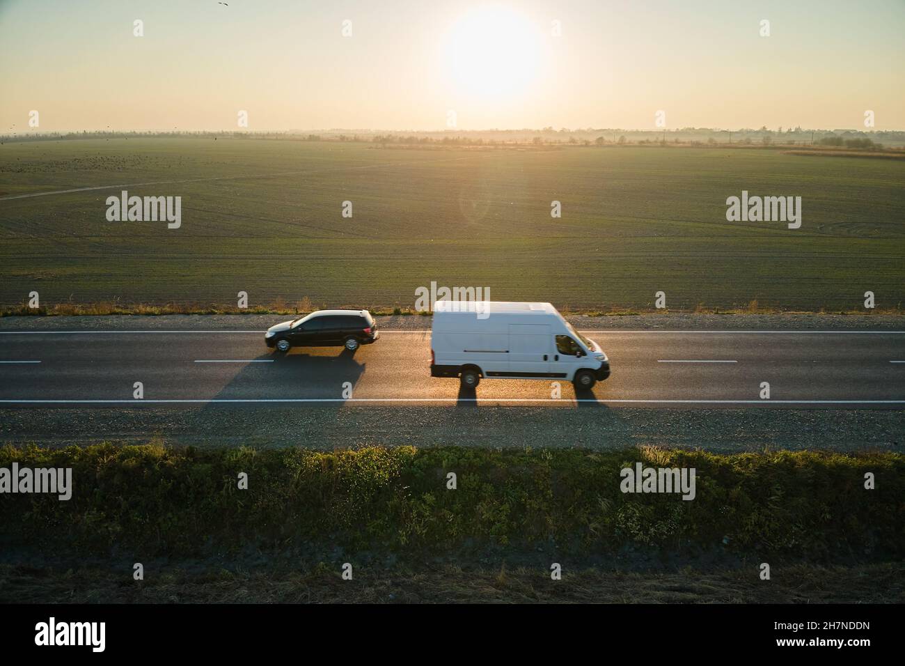 Aerial view of blurred fast moving cargo van driving on highway hauling ...
