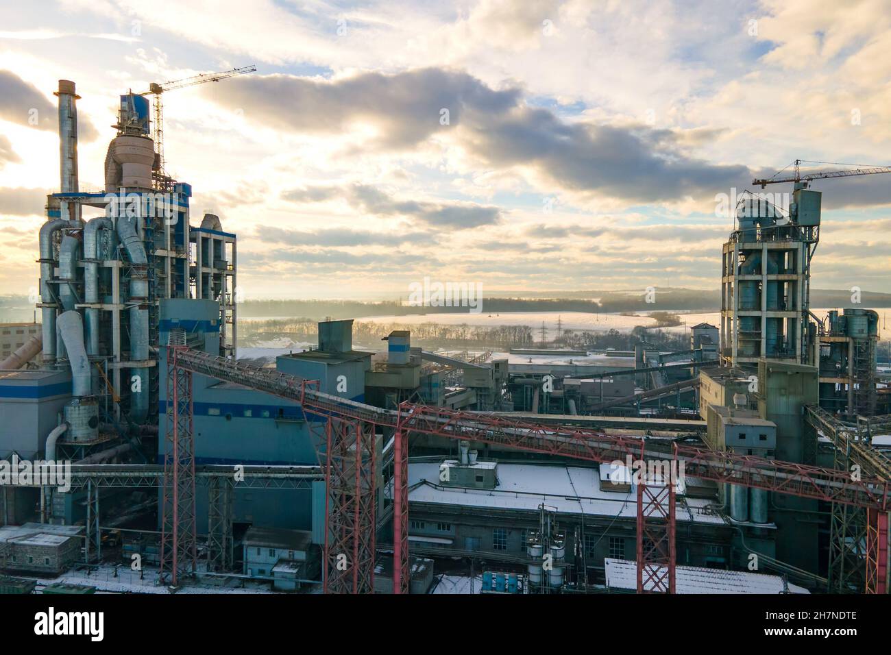 Aerial view of cement plant with high factory structure and tower crane ...