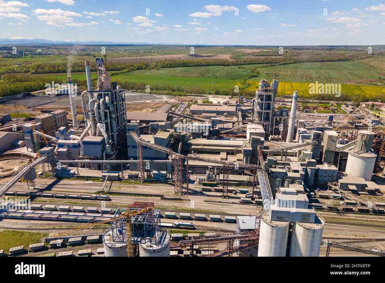 Aerial view of cement factory with high concrete structure and tower ...