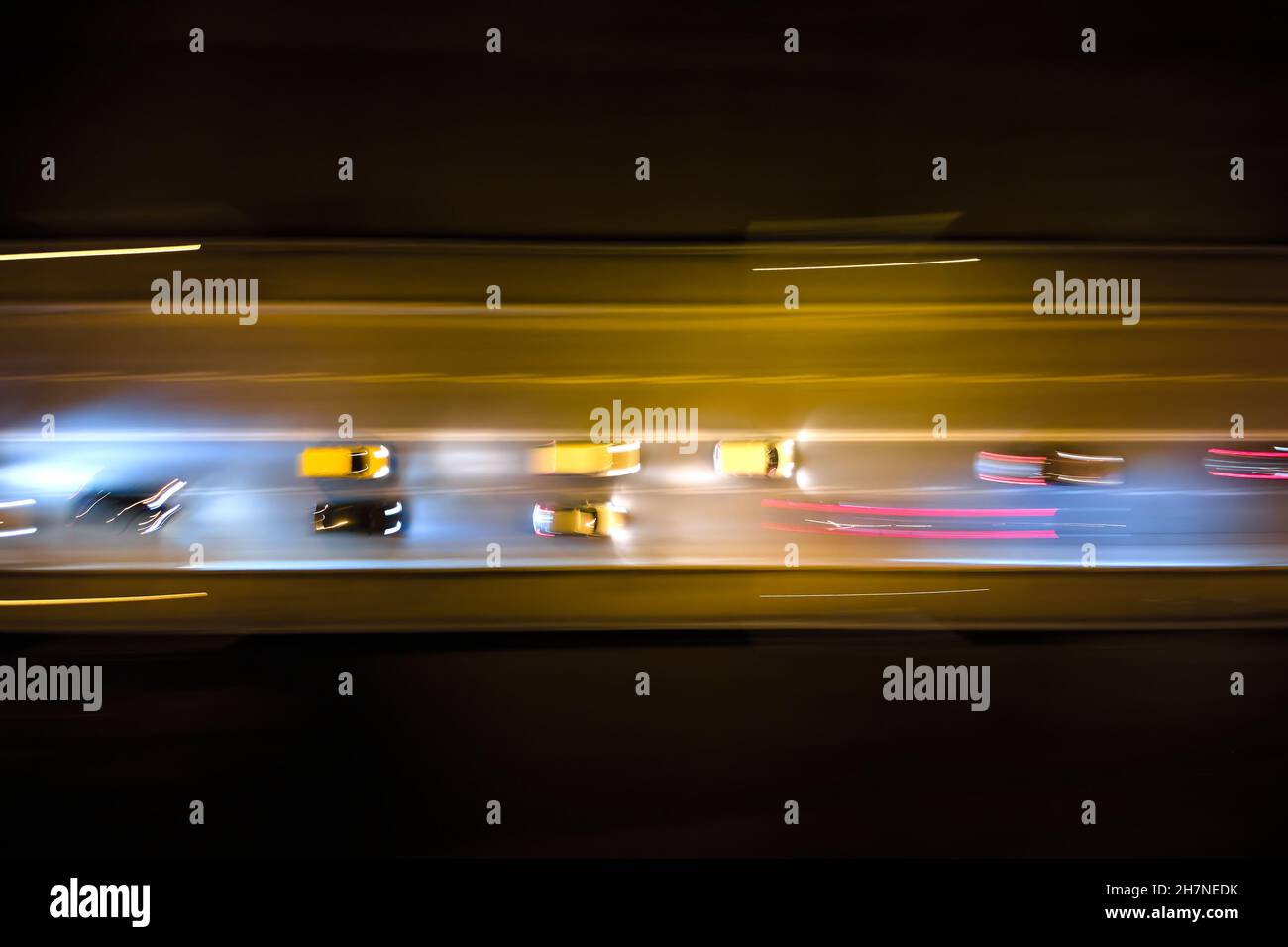 Aerial view of road with fast moving heavy traffic at night. Top view ...