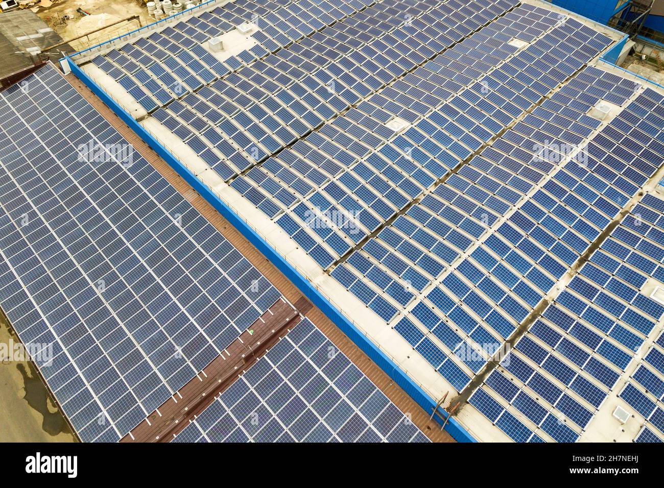 Aerial view of solar power plant with blue photovoltaic panels mounted ...