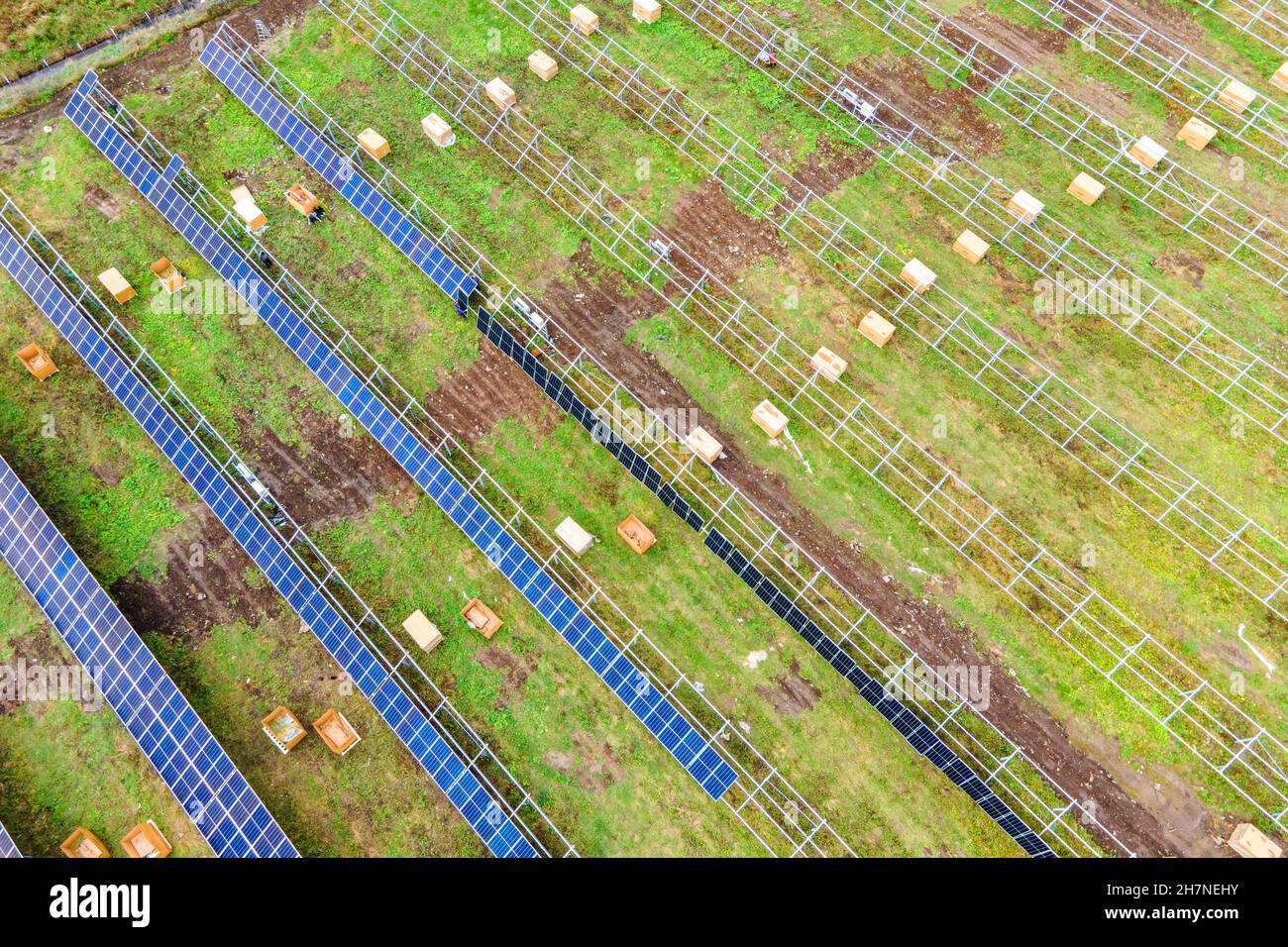 Aerial view of solar power plant under construction on green field ...