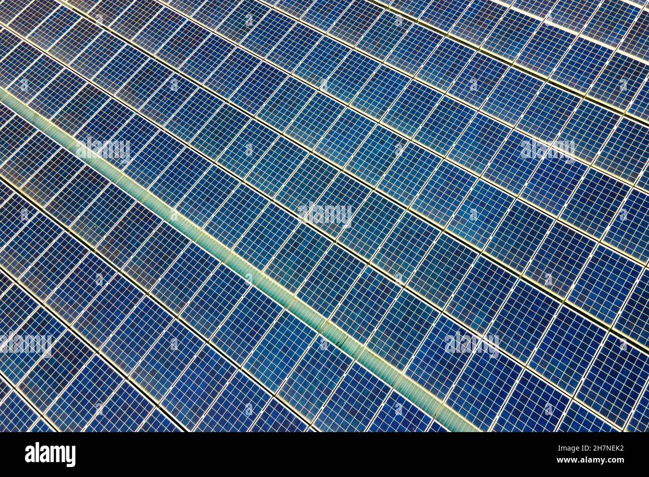 Aerial view of surface of blue photovoltaic solar panels mounted on ...