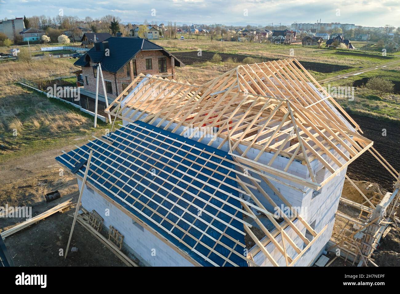 Aerial view of unfinished frame of private house with aerated ...