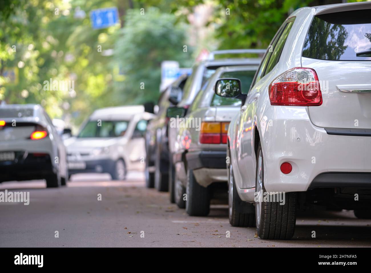 City traffic with cars parked in line on street side Stock Photo - Alamy