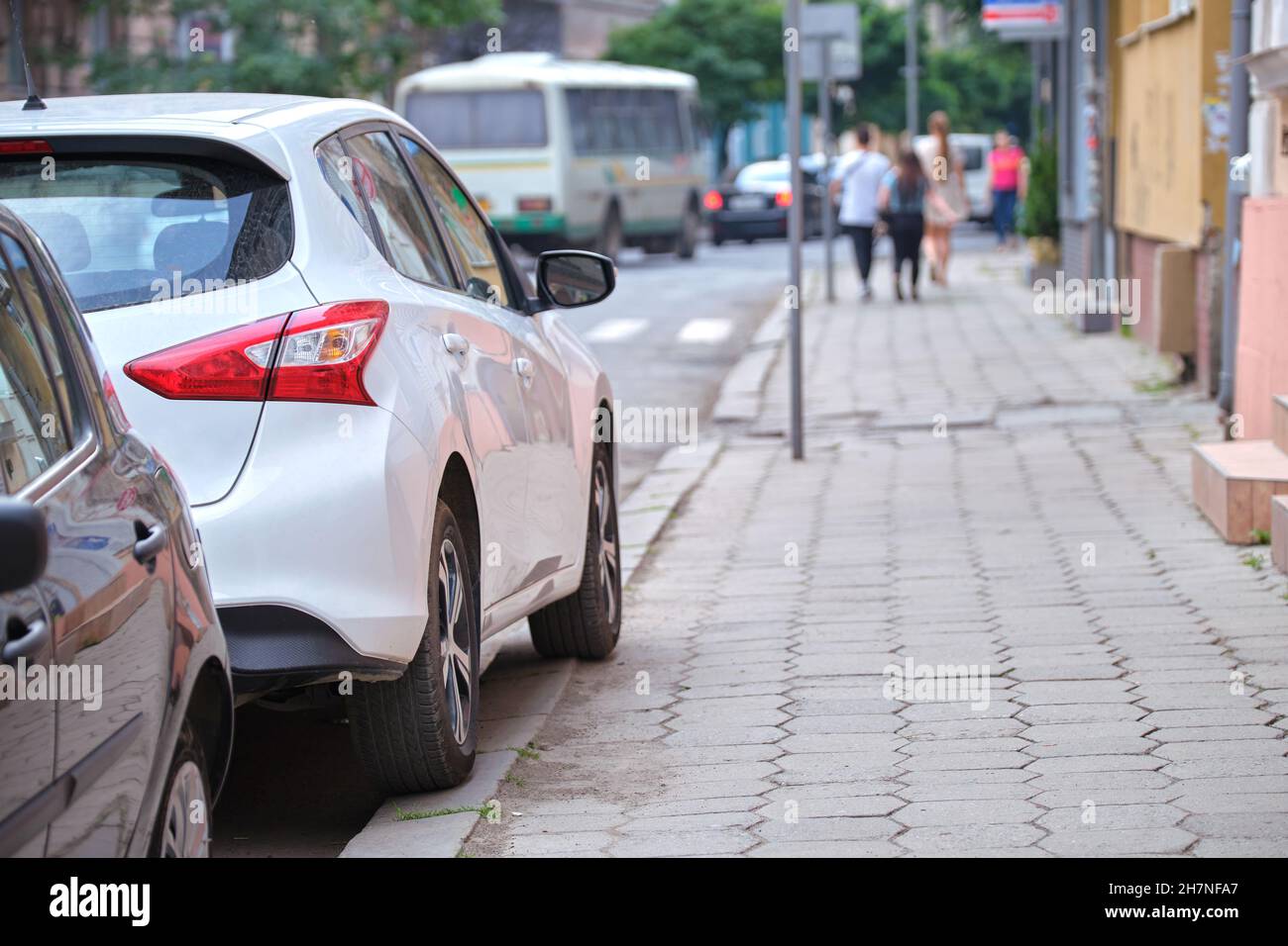 City traffic with cars parked in line on street side Stock Photo - Alamy