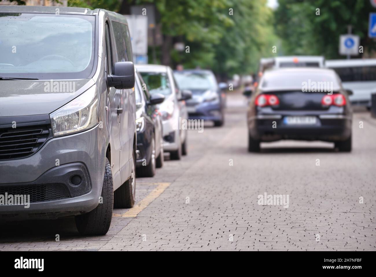 City traffic with cars parked in line on street side Stock Photo - Alamy