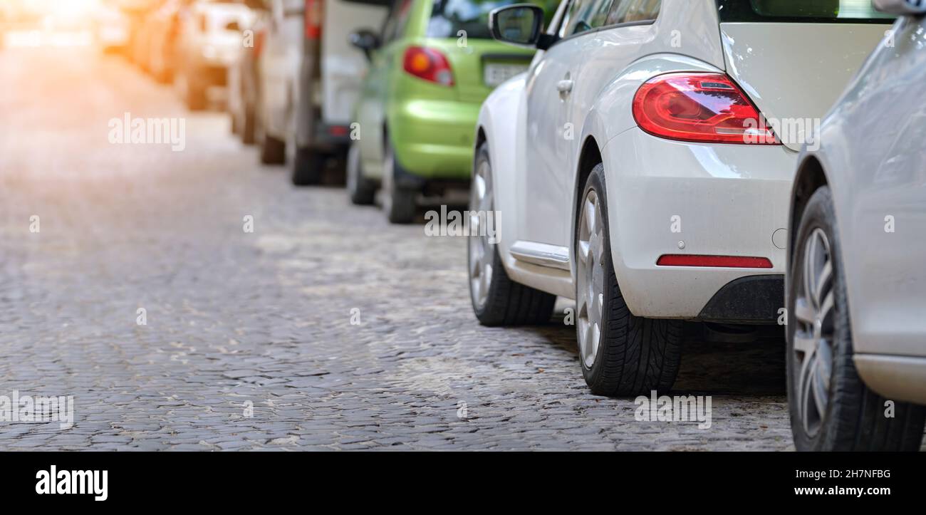 City traffic with cars parked in line on street side Stock Photo - Alamy