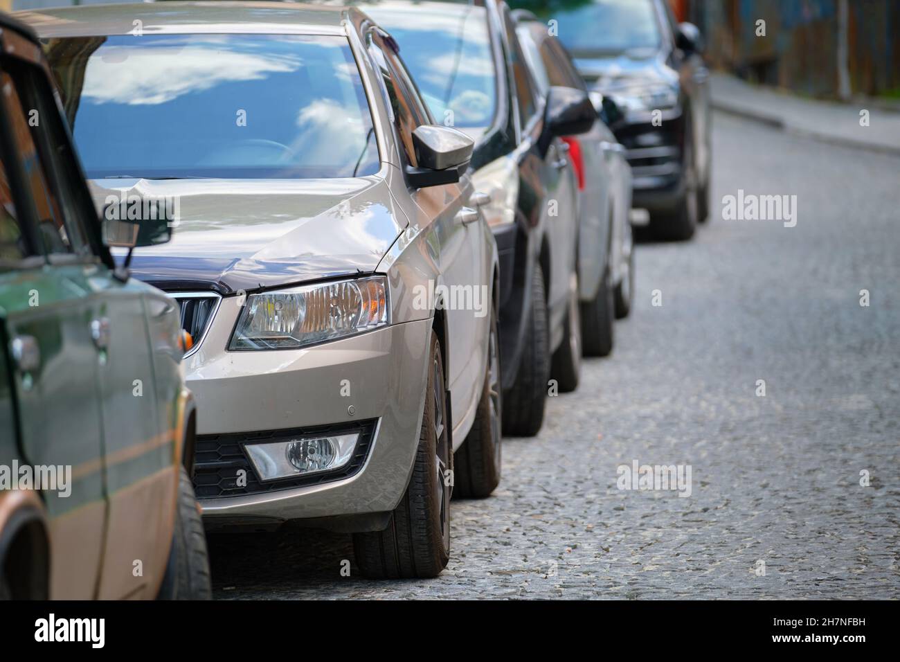 City traffic with cars parked in line on street side Stock Photo - Alamy