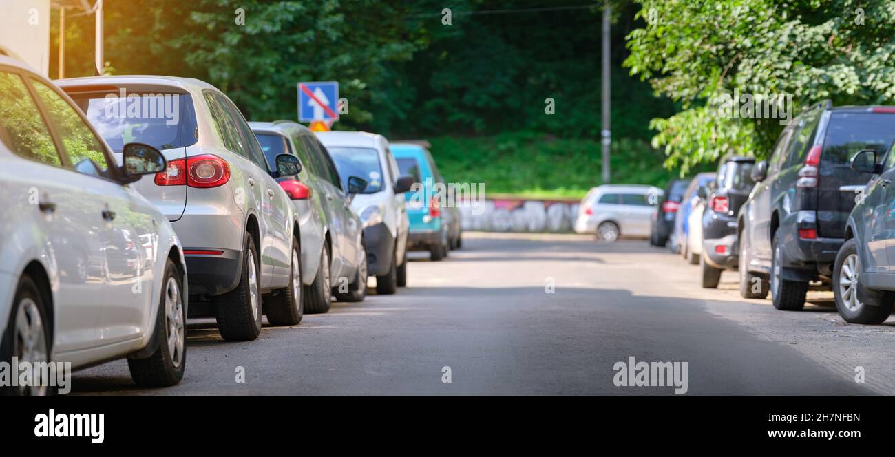 City traffic with cars parked in line on street side Stock Photo - Alamy