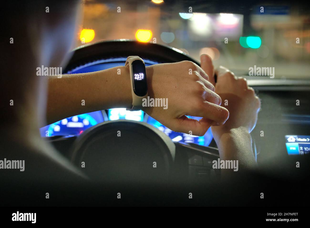 Close up of driver hand with digital watch checking time holding ...