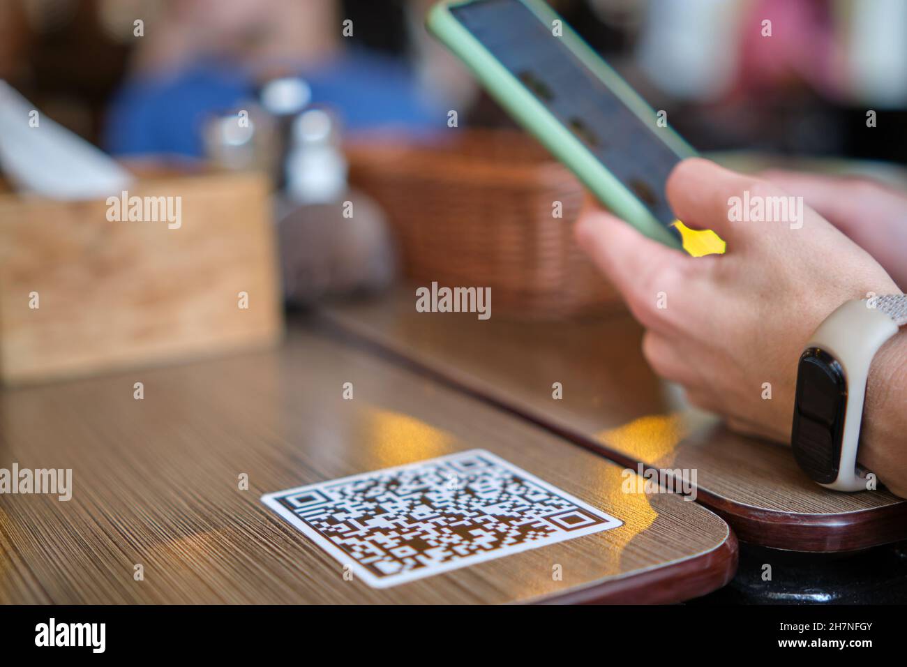 Closeup of guest hand ordering meal in restaurant while scanning qr ...