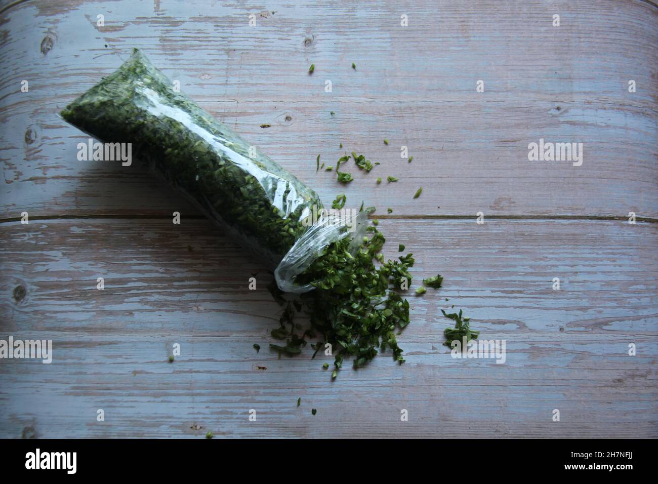 Parsley: Fresh, chopped in a clear plastic wrap with selective focus on ...