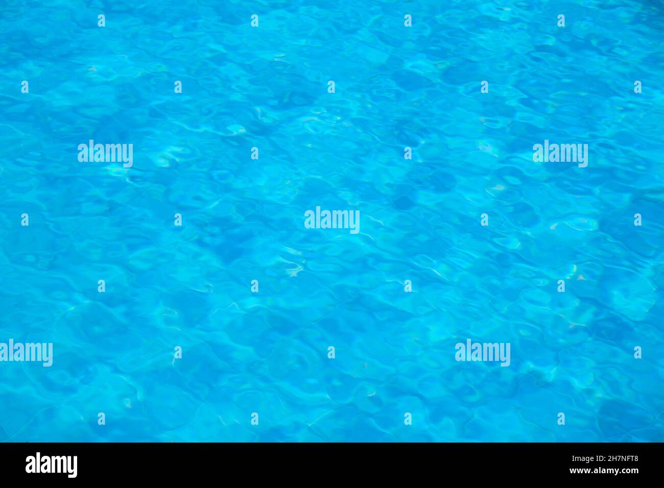 Closeup surface of blue clear water with small ripple waves in swimming ...