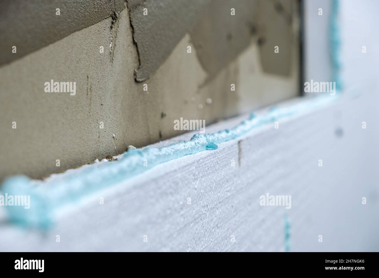 Installation of styrofoam insulation sheets on house facade wall for ...