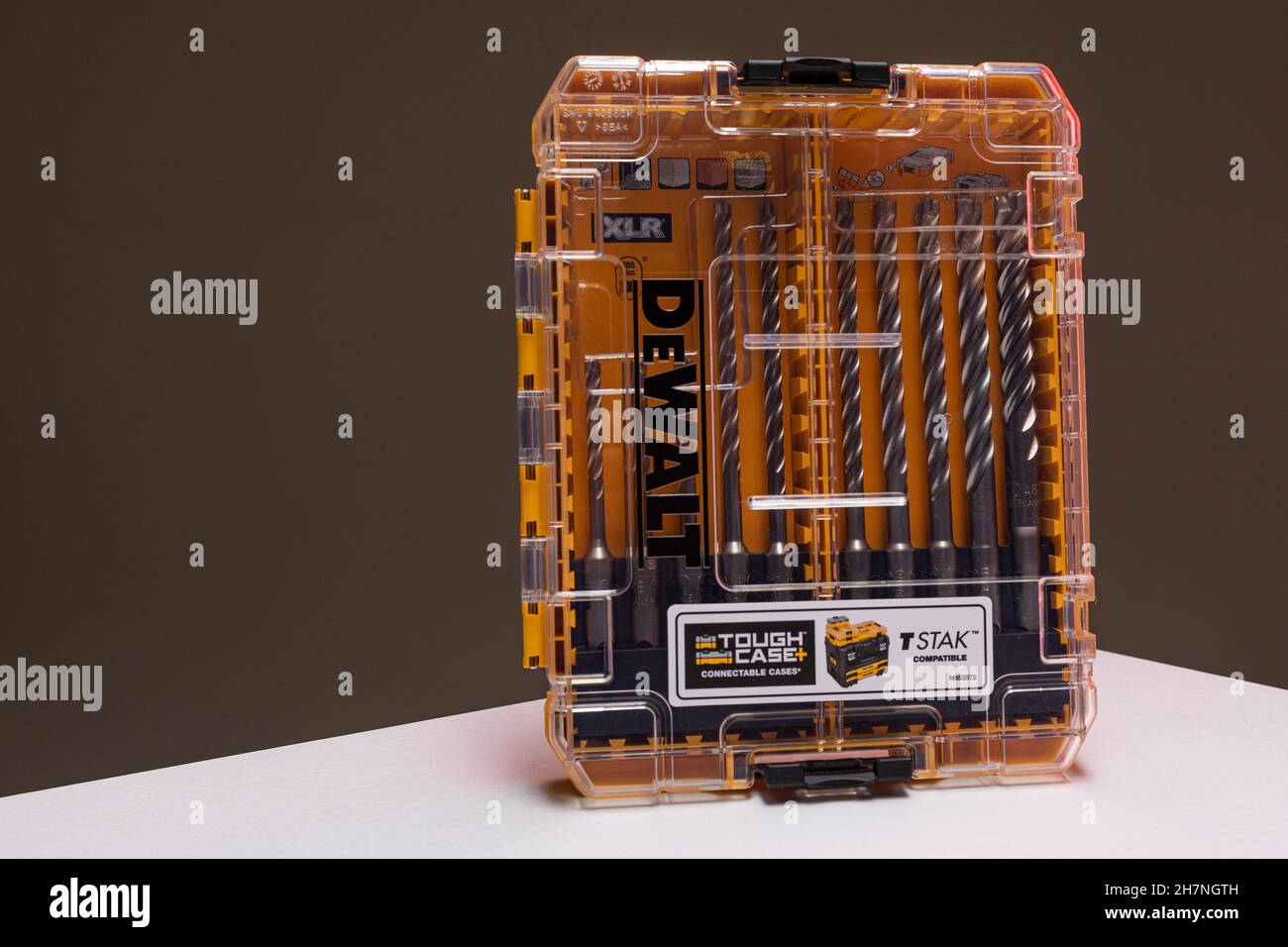 Photo shot of yellow and transparent kit box with drills for drilling ...
