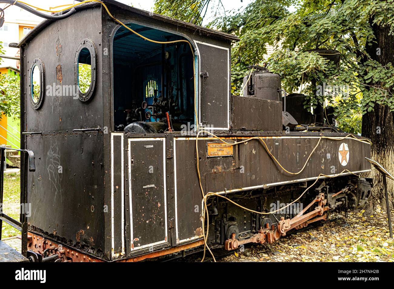 Closeup of an old rusty abandoned train part with trees on the ...