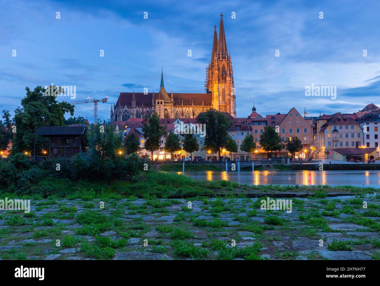 Regensburg. Old medieval cathedral on the banks of the Danube at sunset ...
