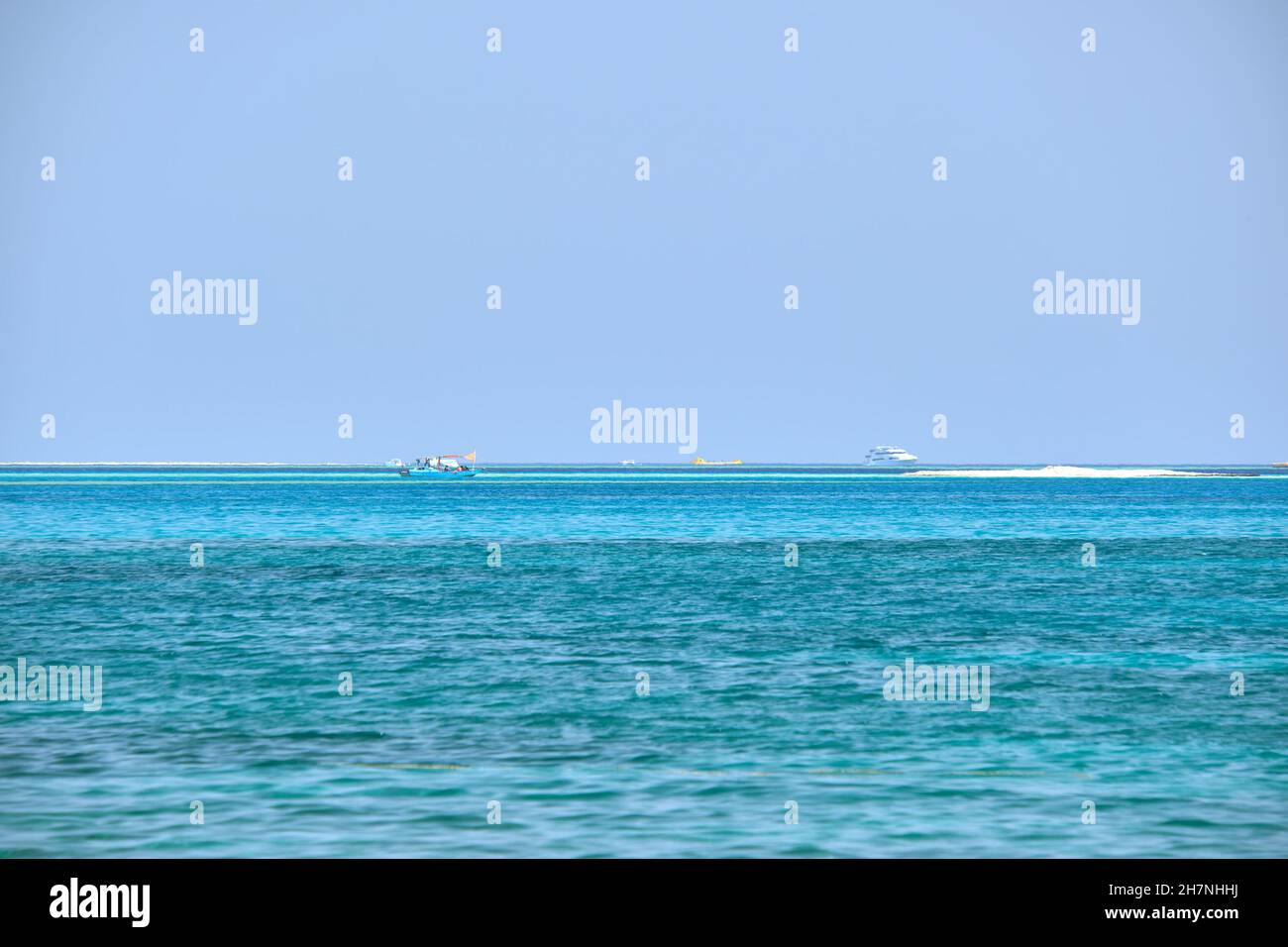 Seascape with ripple surface of blue sea water with distant ships ...