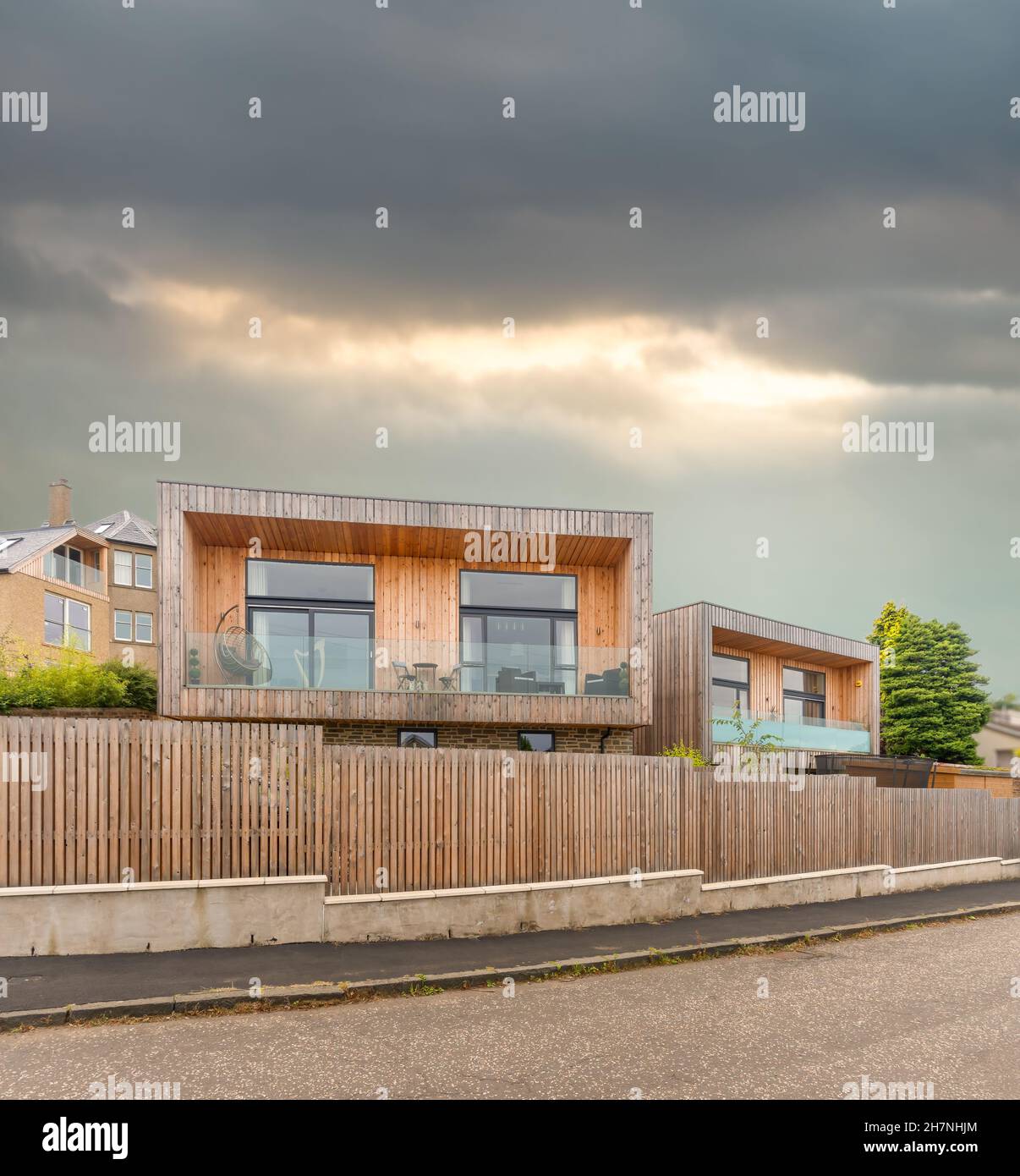 Edinburgh, Scotland, UK - Two modern timber houses with stormy sky ...