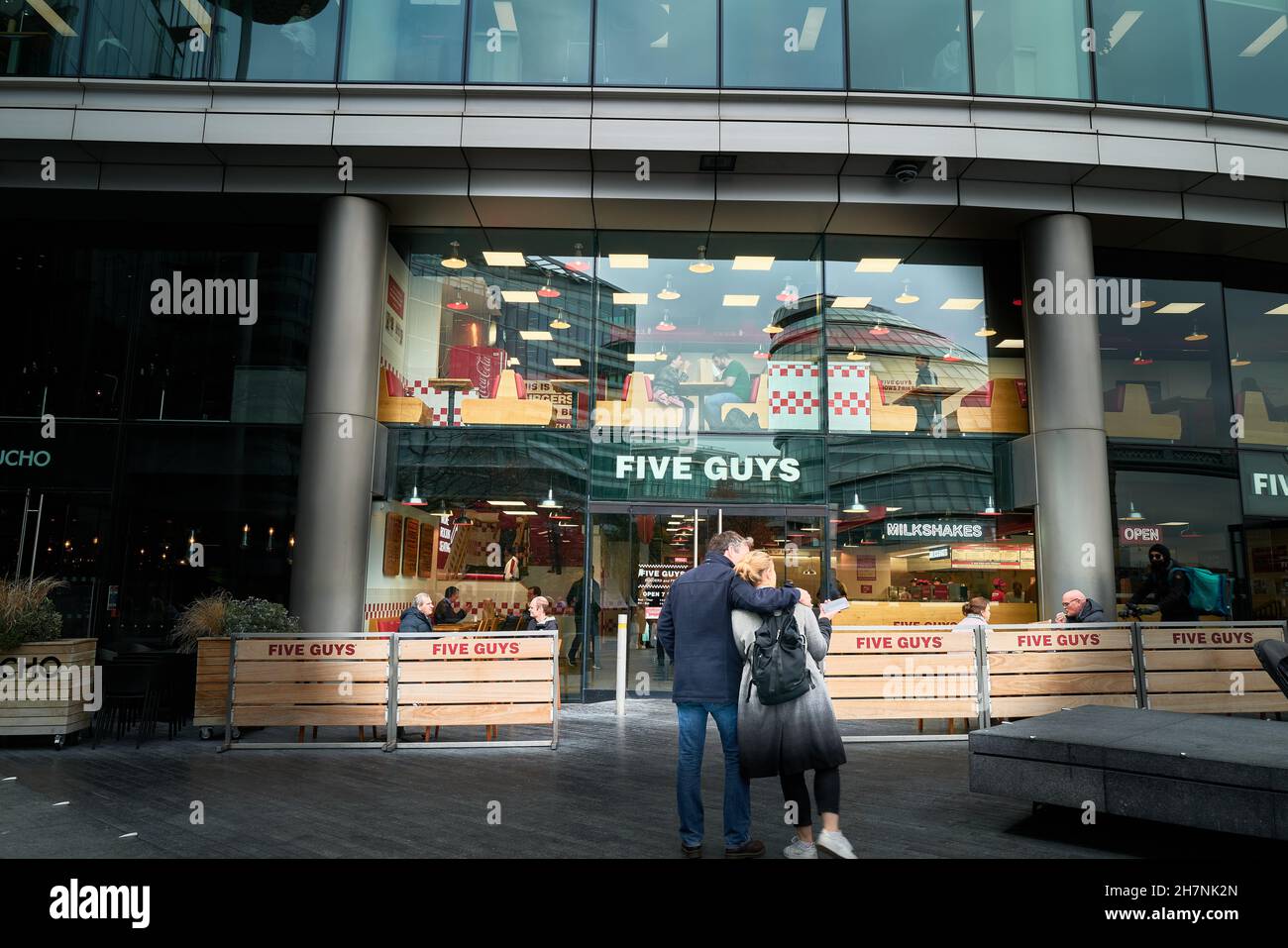 A couple outside Five Guys cafe, south bank river Thames, London ...