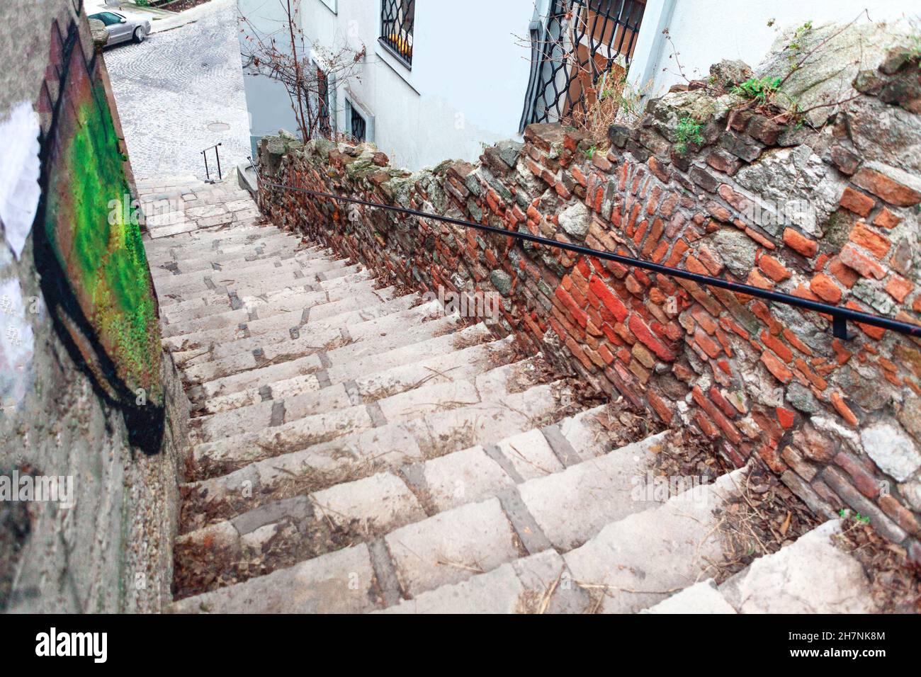 Staircase and brick wall in old town . Old stone stairs in the city ...