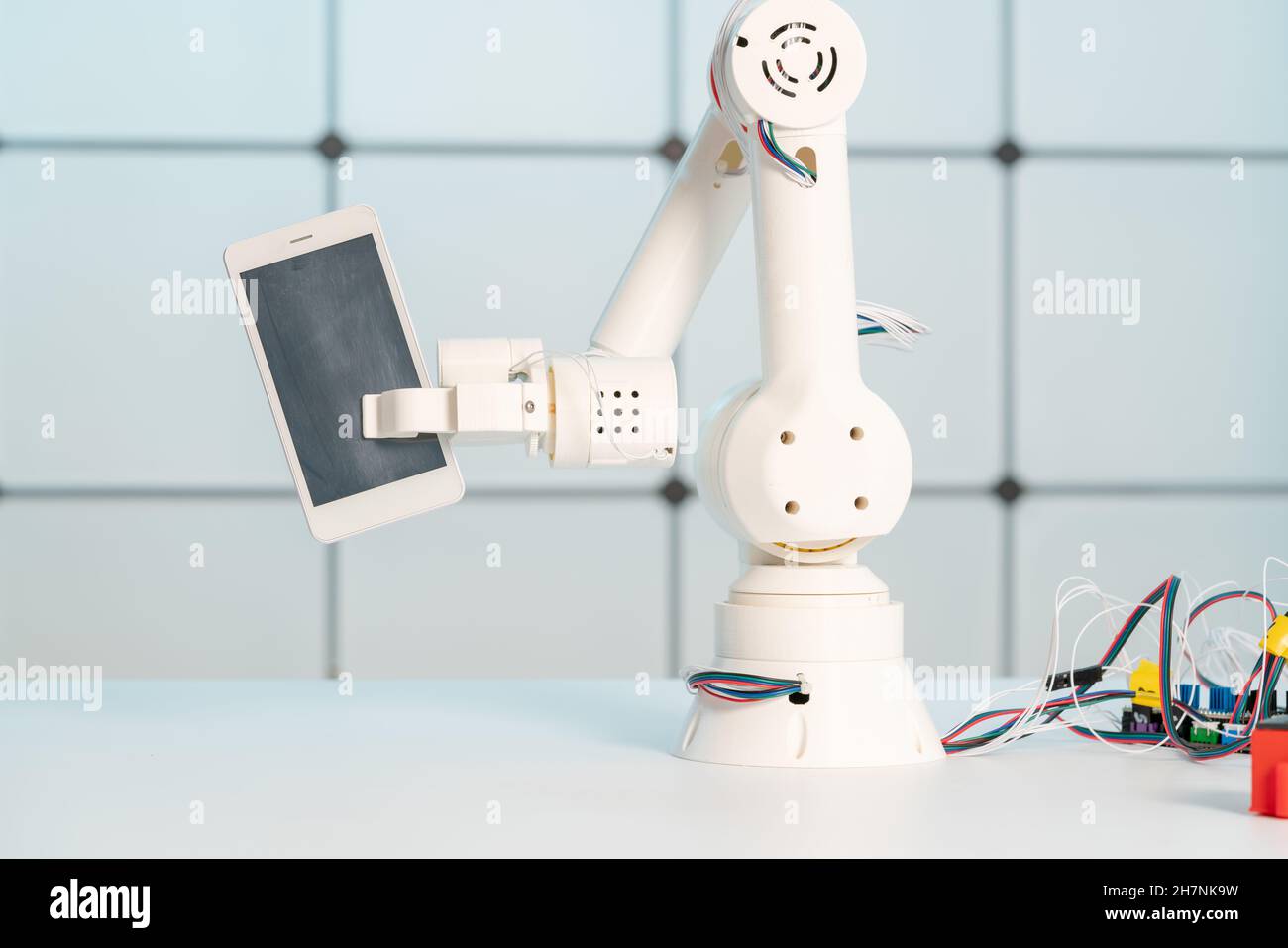 Phone in robot arm, bot concept on customer support hotline. Using ...