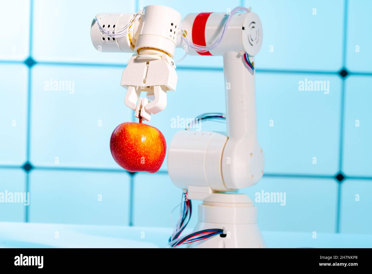 Robot arm with red apple. robot hand is holding a red apple. Modern ...