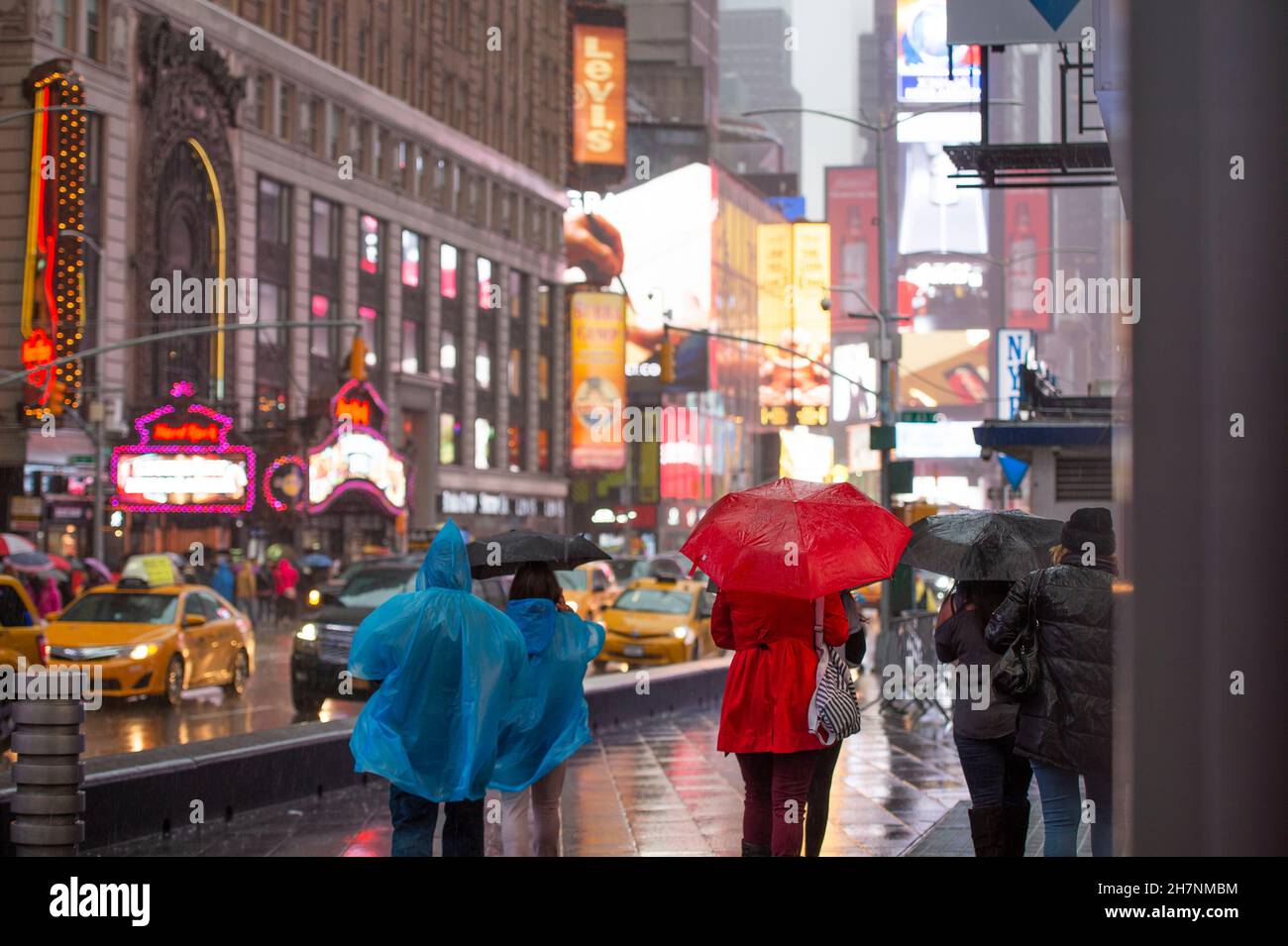 Some people are walking in Times Square during a rainy day Stock Photo ...