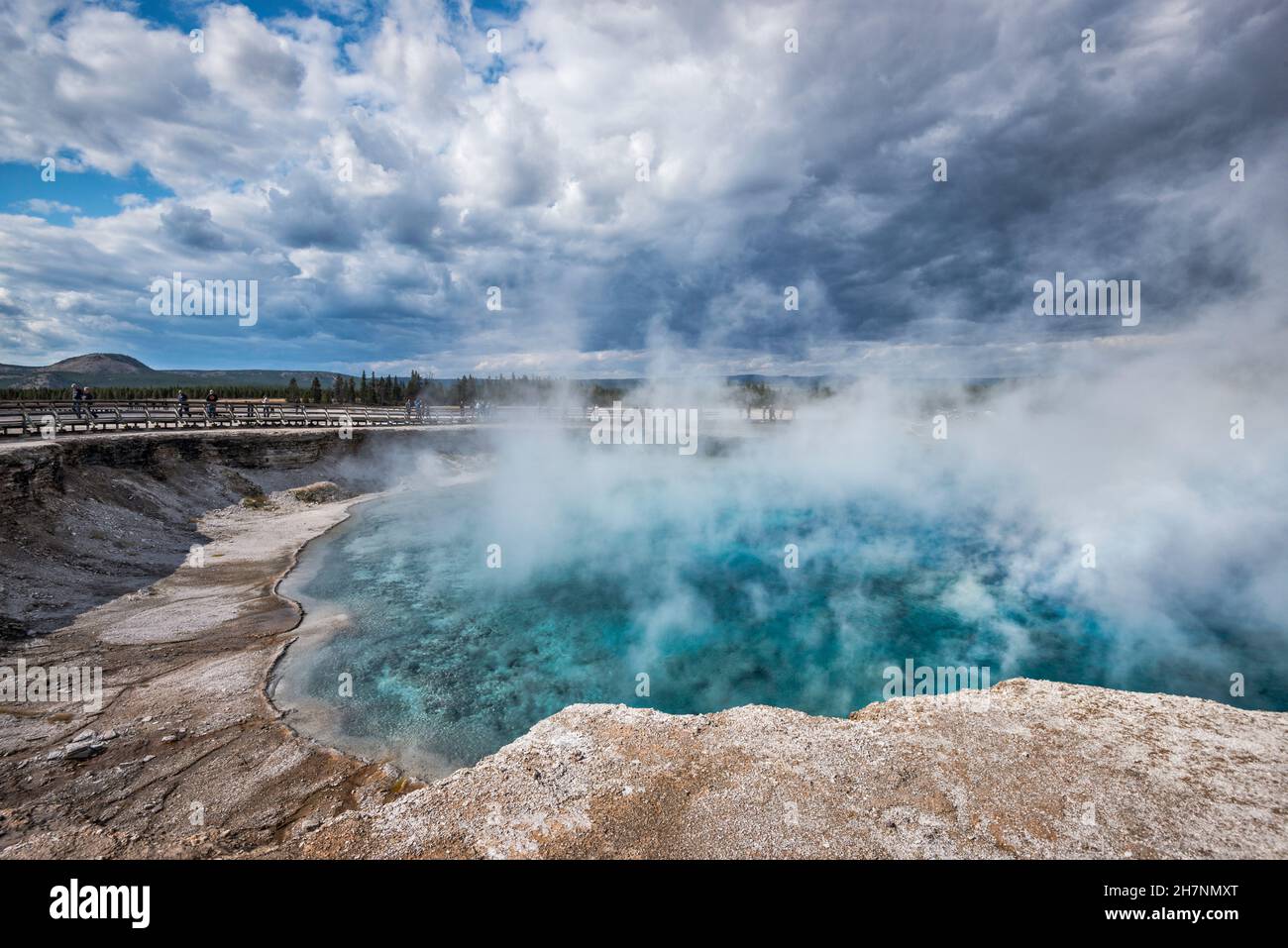 Storm clouds, steam rising from Excelsior Geyser Crater, now hot spring ...