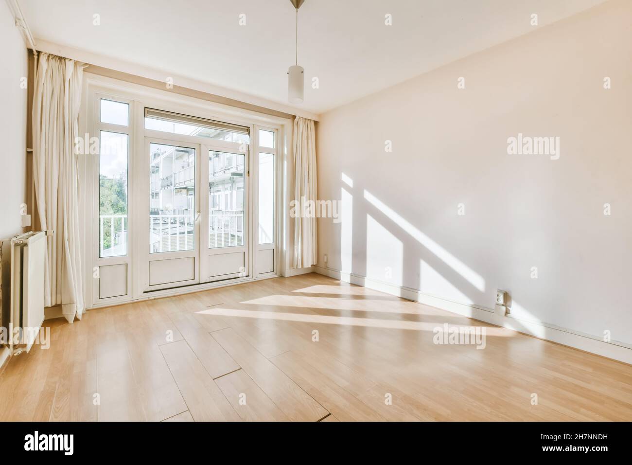 Large bright room with huge windows and street views Stock Photo - Alamy