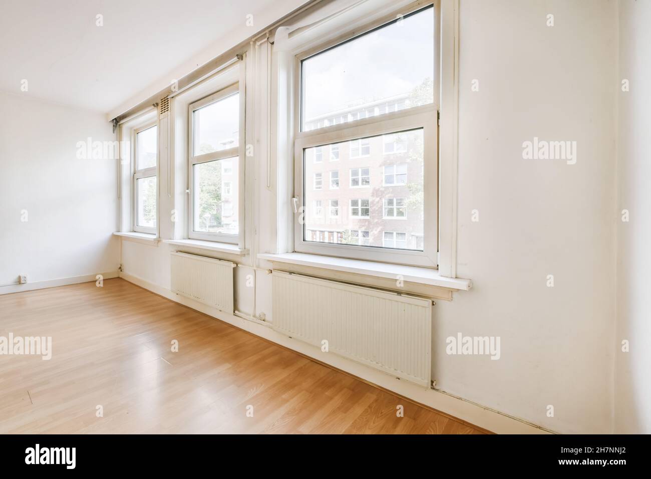 Large bright room with huge windows and street views Stock Photo - Alamy