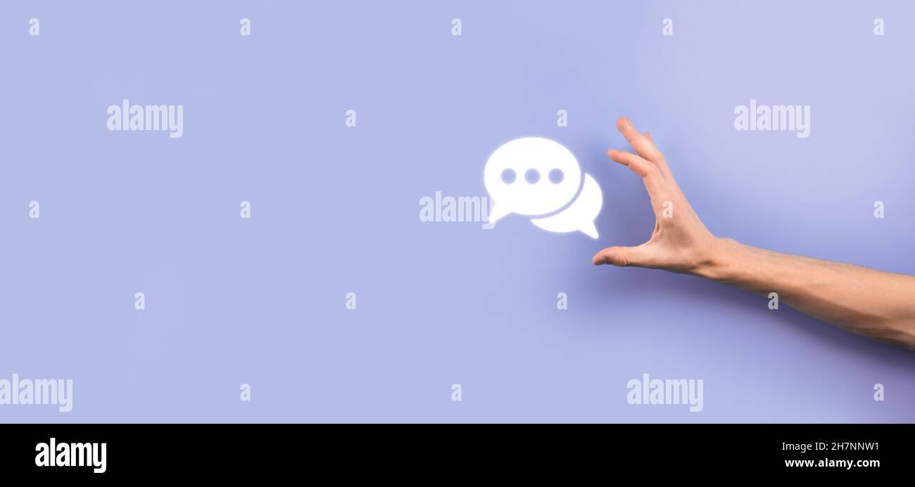 Businessman holding a message icon, bubble talk notification sign in ...