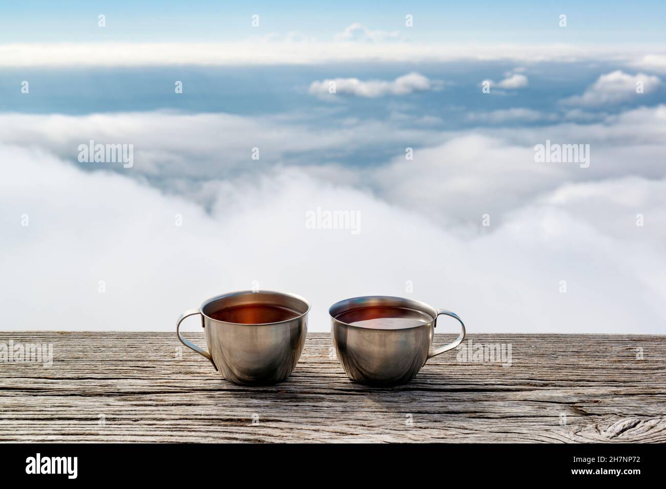 Two cups of herbal tea in an alpine rest place with amazing view on ...