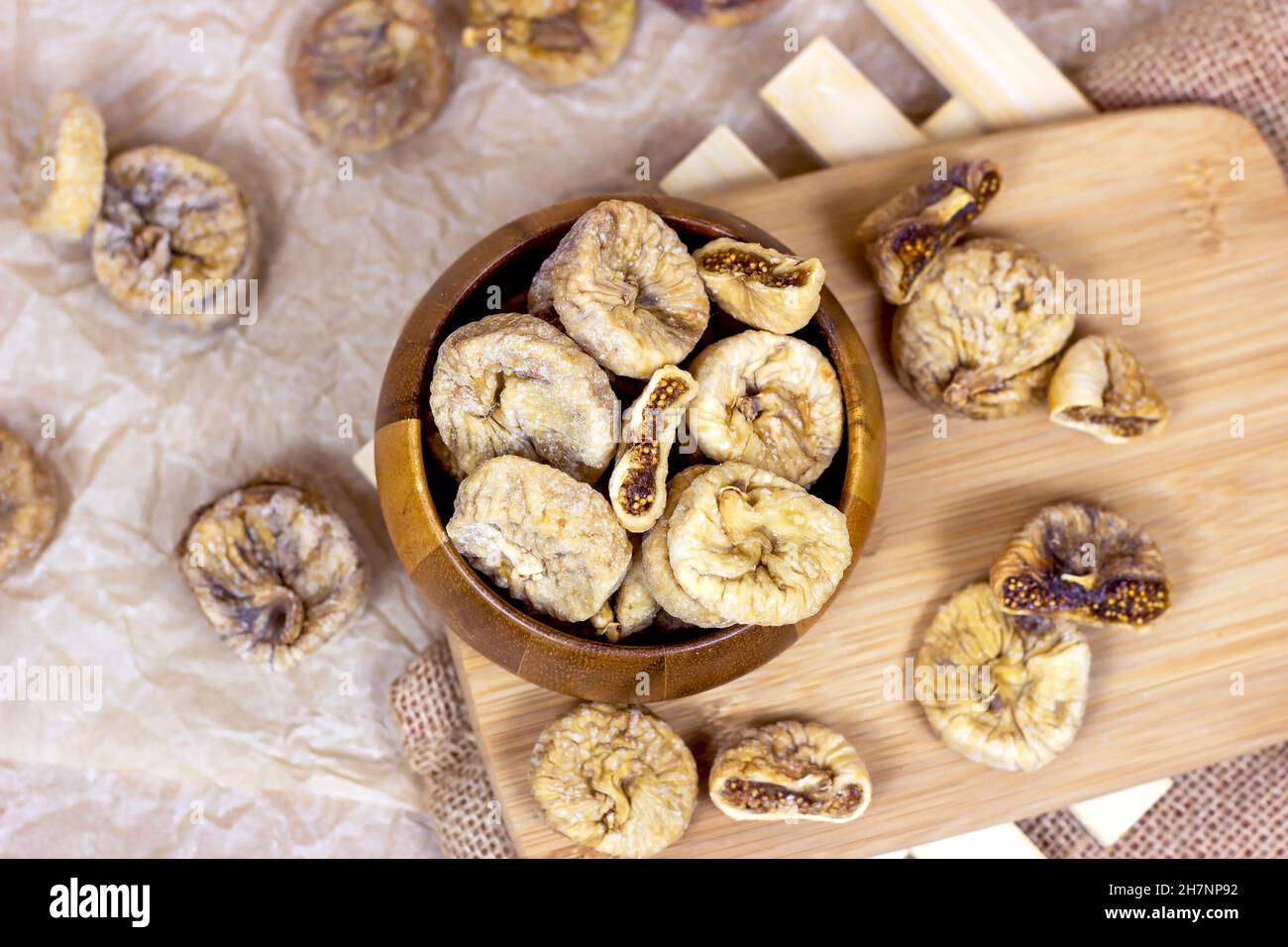 Top view of sweet dried italian figs in the wooden bowl on the brown ...
