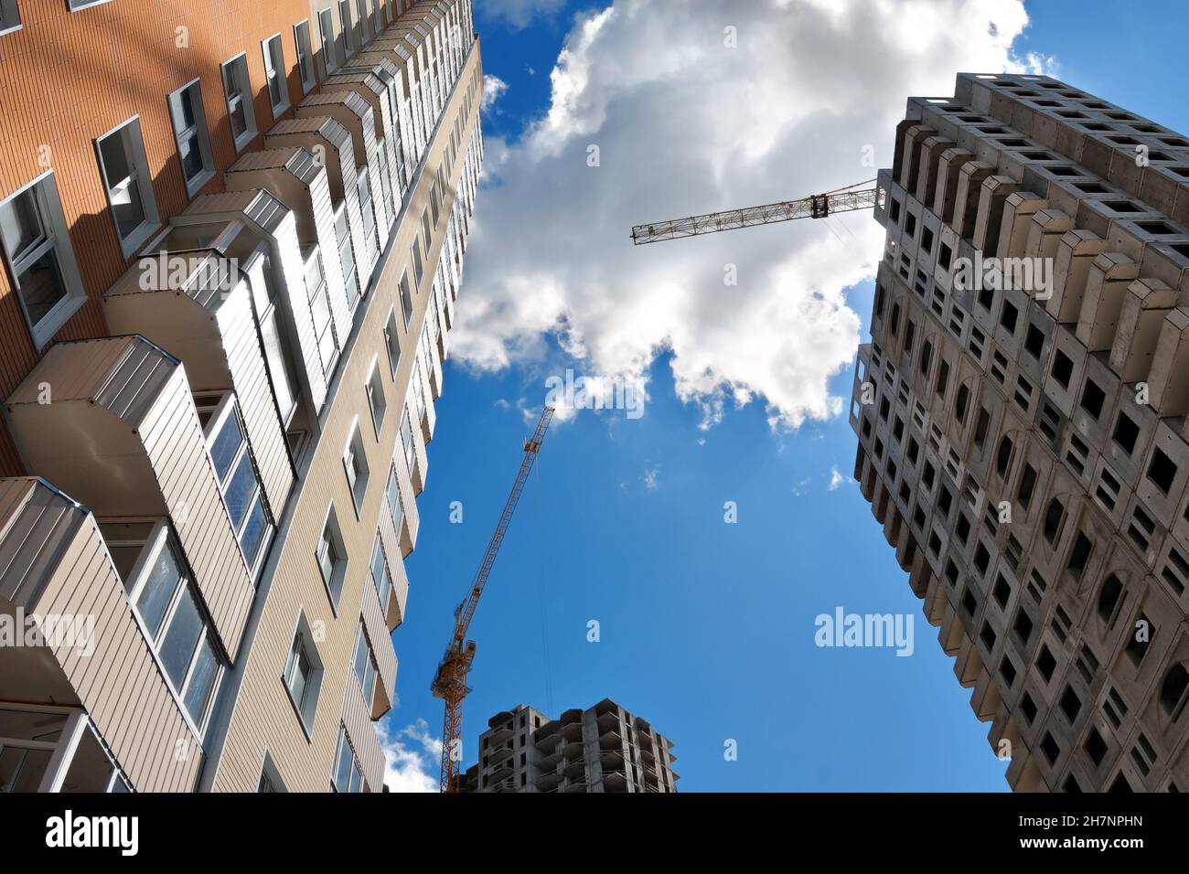 High residential houses under construction against blue sky, view up ...
