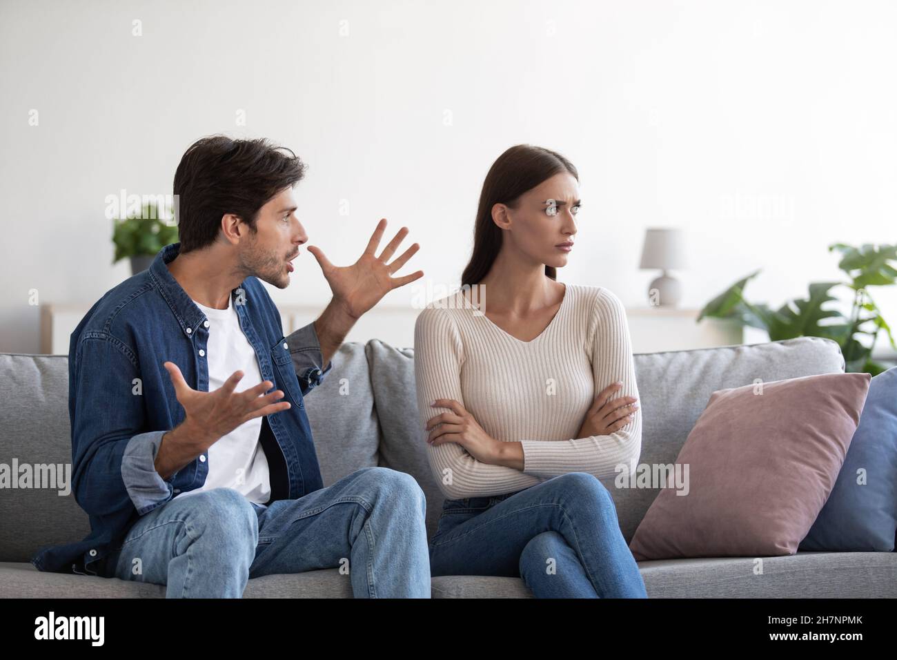 Evil Angry European Millennial Husband Yelling At Wife At Sofa In