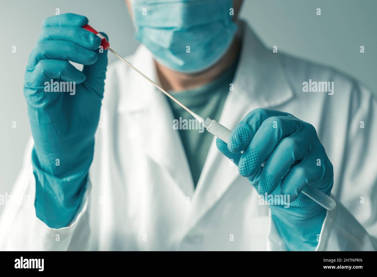 Medical professional with sample swab in clinic laboratory during Covid ...