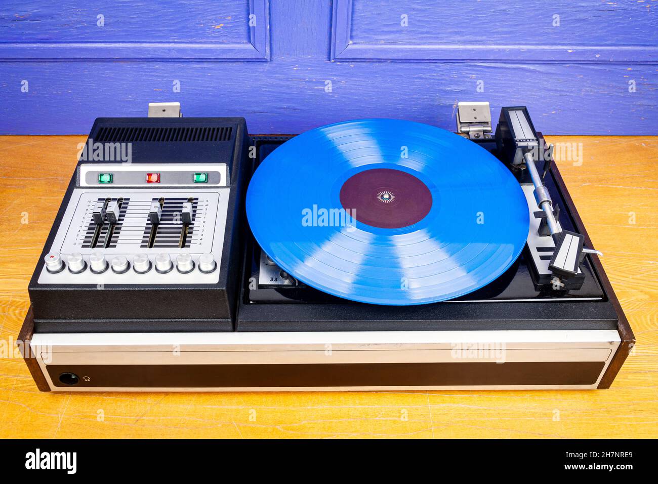 Vintage turntable vinyl record player with blue vinyl on a table Stock ...