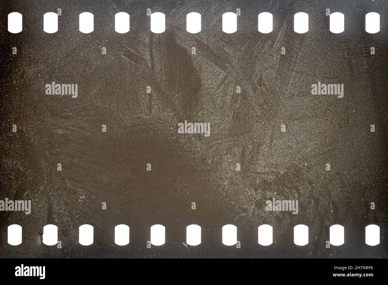 Dusty and grungy 35mm film texture or surface. Perforated camera film ...